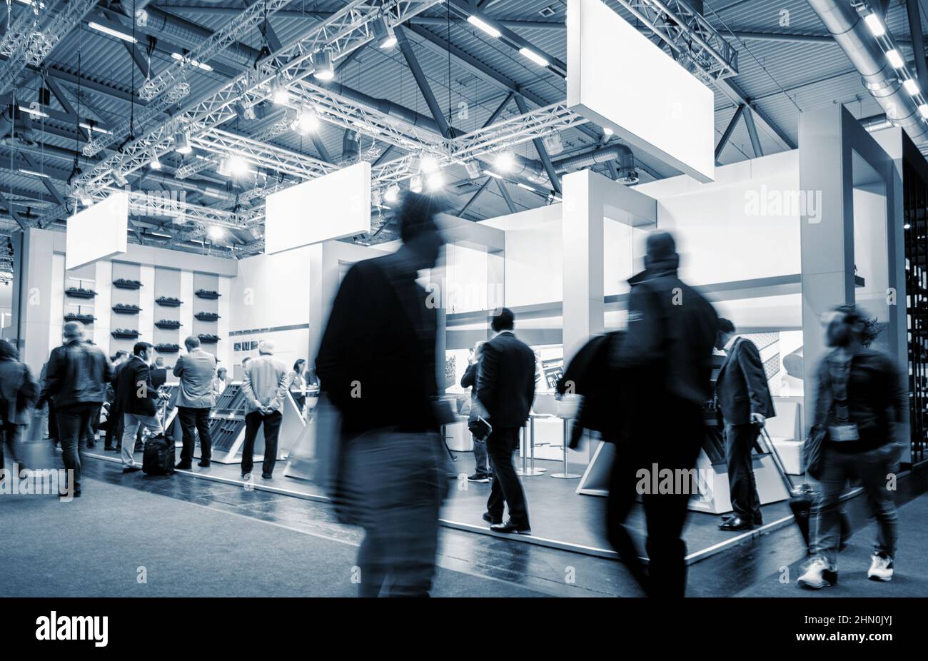 business people walking at a trade show booth at a public event ...