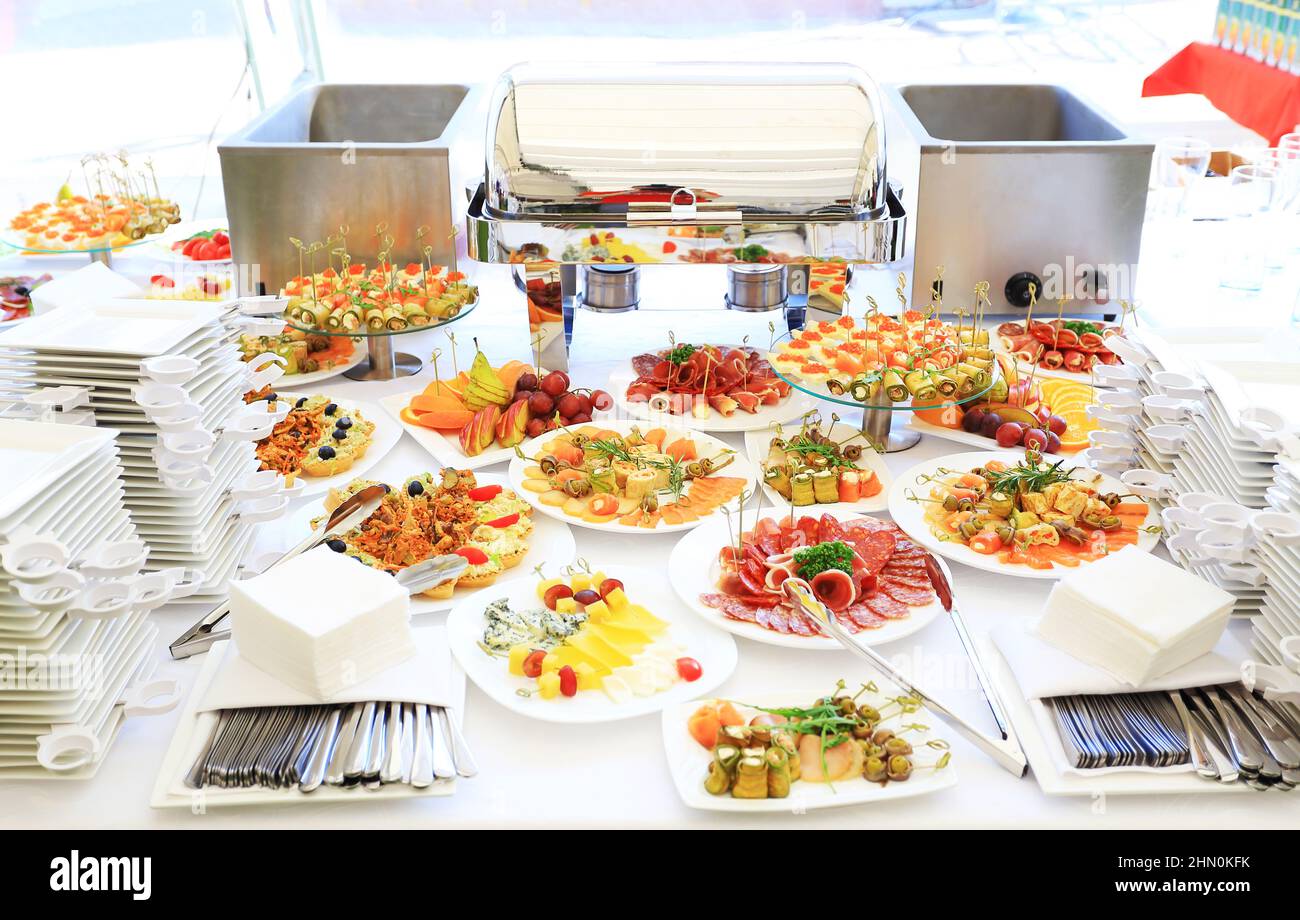 catering table set service with silverware and glass stemware at ...