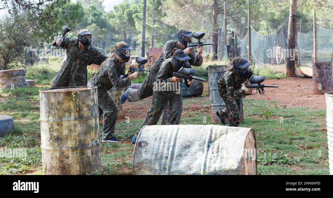 Group of people playing paintball Stock Photo - Alamy