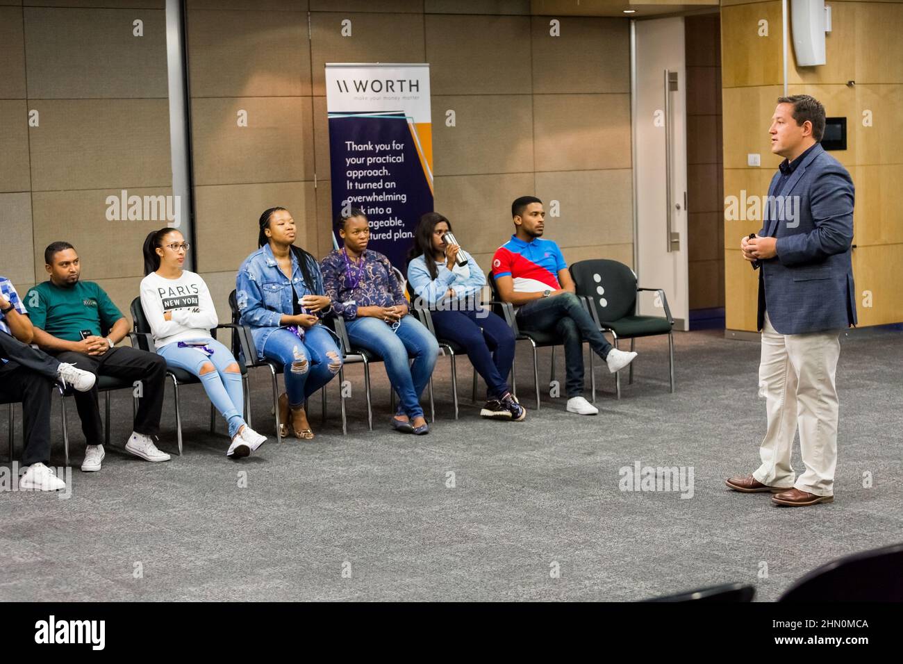 Educator instructing diverse adult students on personal finance Stock ...