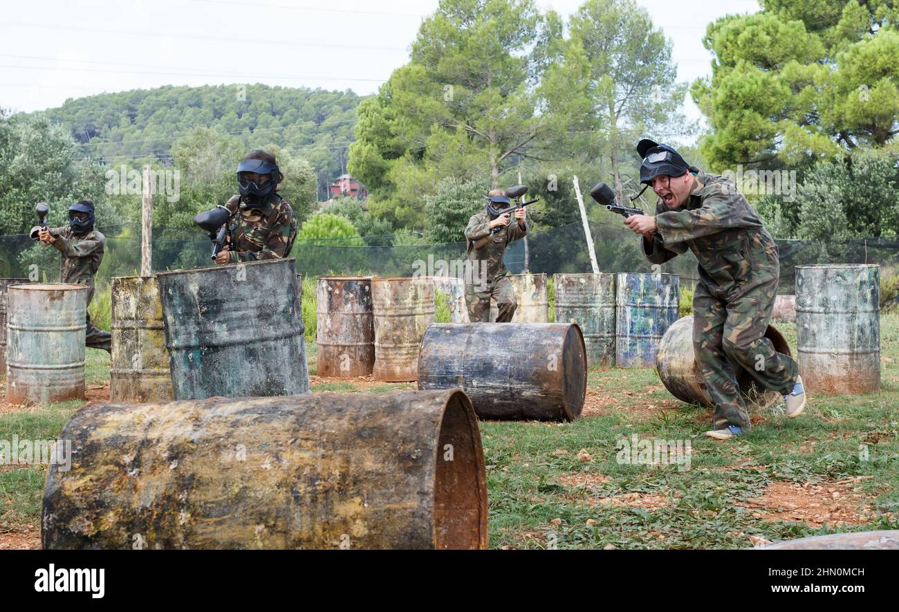 Group of people playing paintball Stock Photo - Alamy