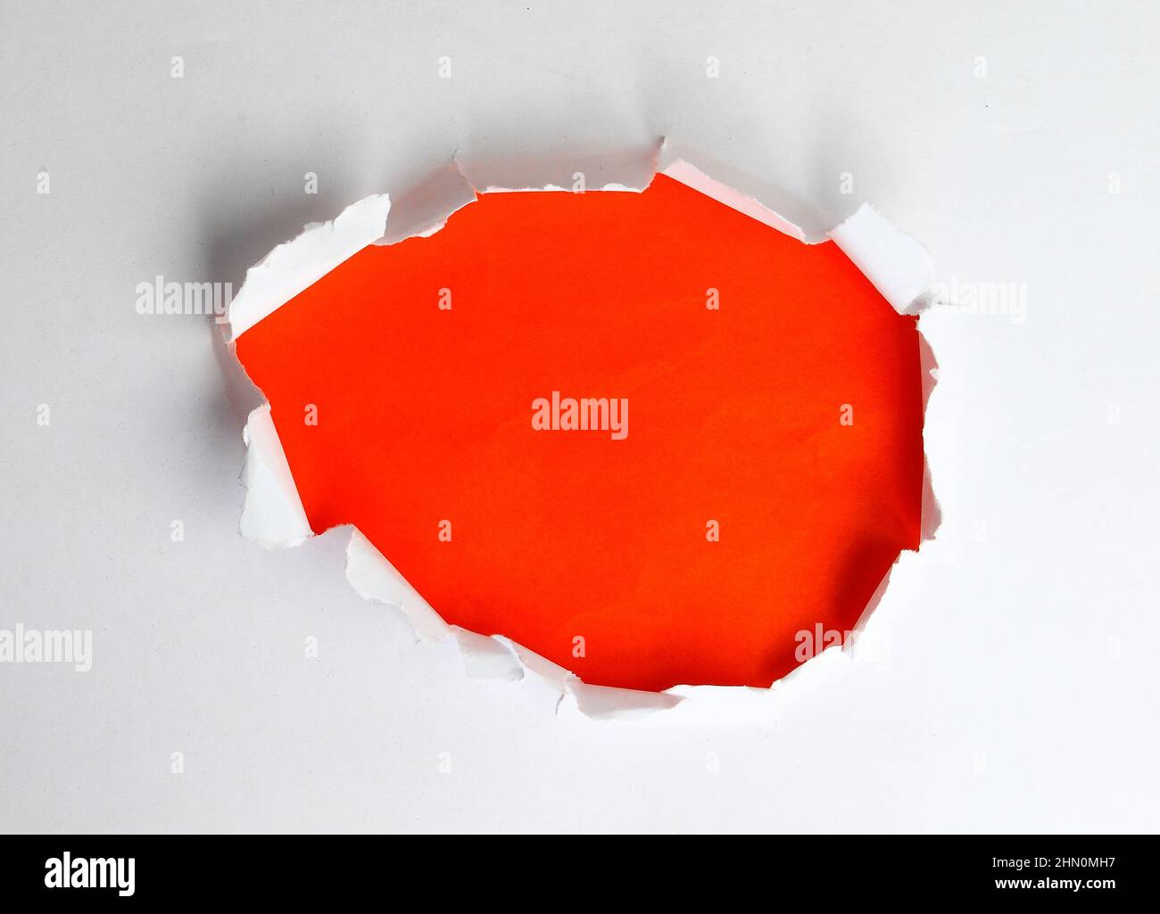Hole in the paper Stock Photo - Alamy
