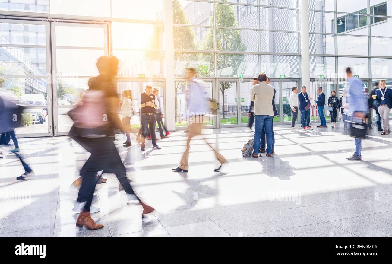 Anonymous business people hurry through trade fair hall Stock Photo - Alamy