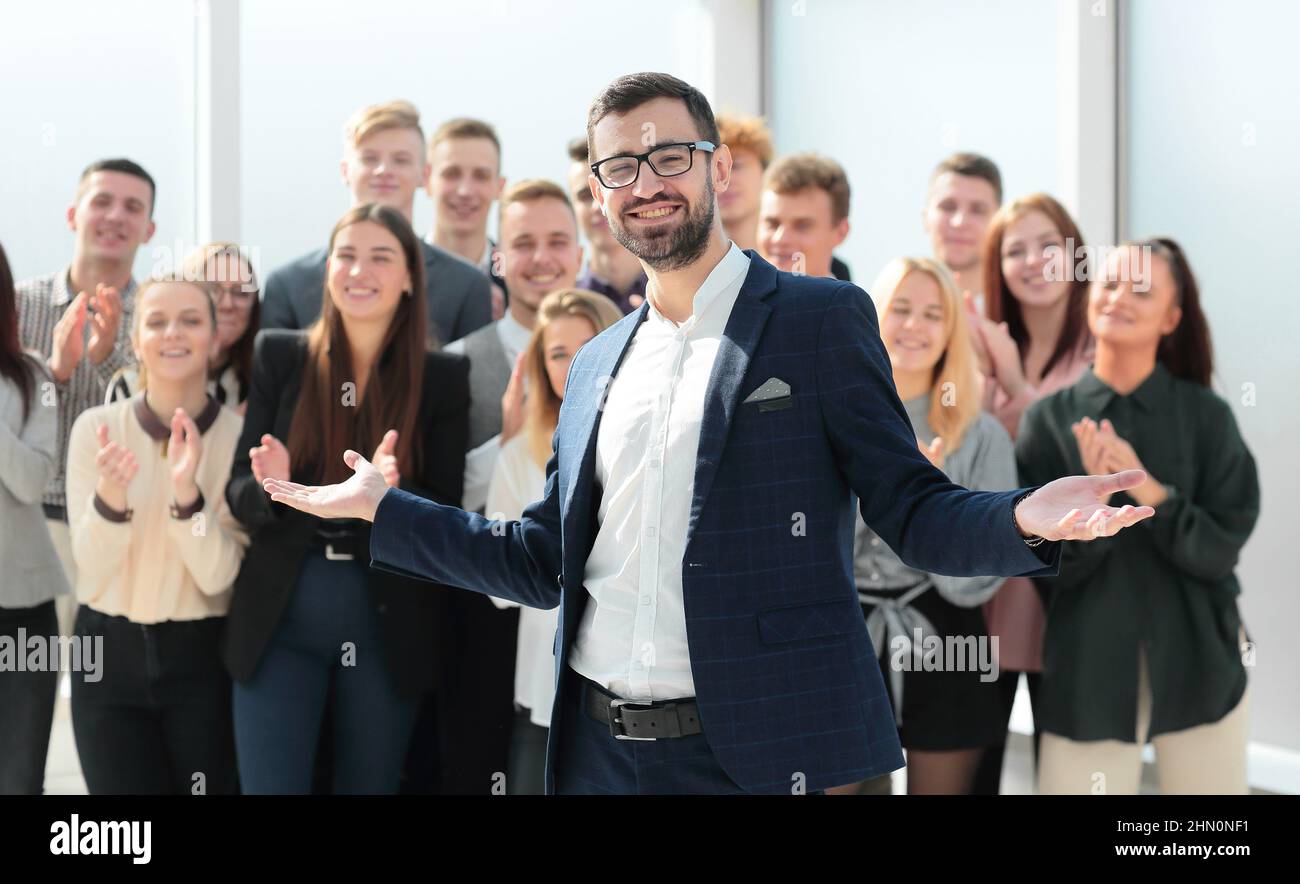 Manager and a group of diverse employees standing in the new office ...