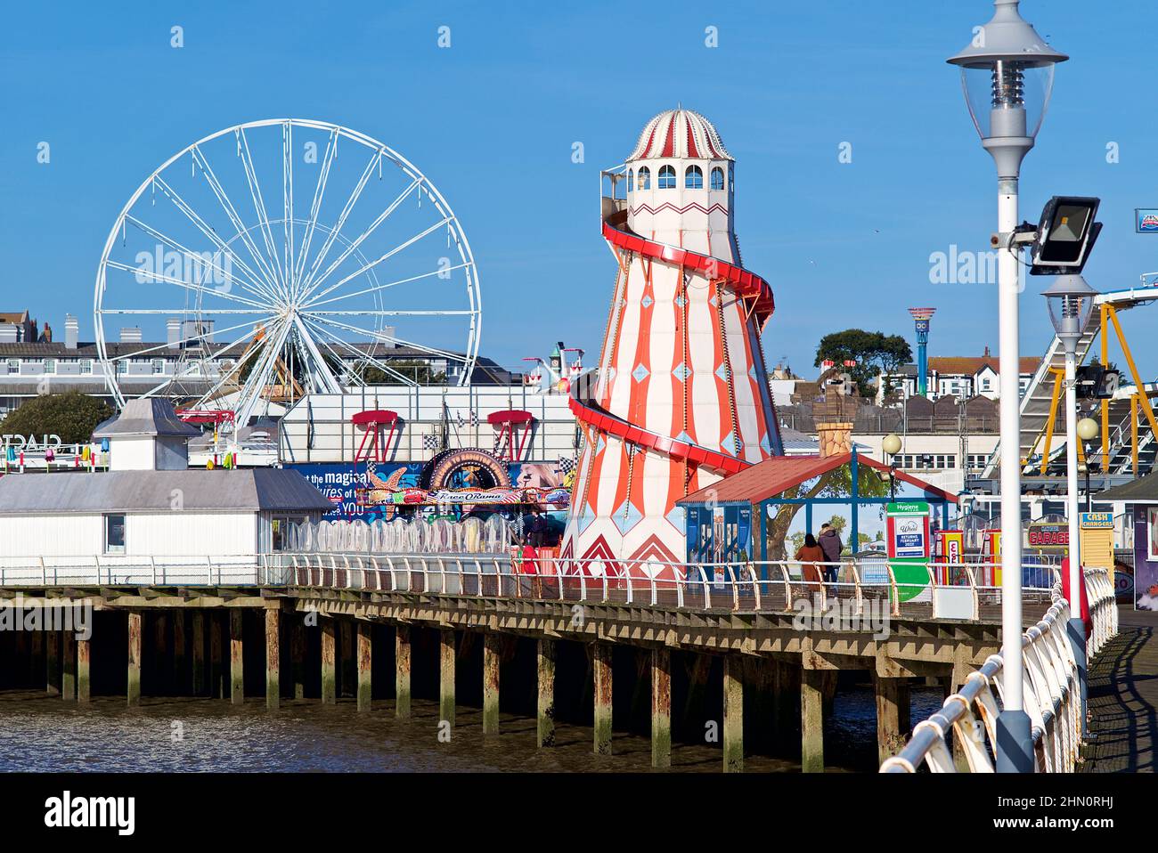 Clacton pier funfair with a big wheel and helter skelter amongst other ...