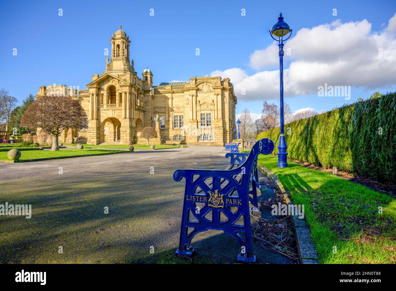 Cartwright Hall in Lister park, Bradford, Yorkshire with park bench ...