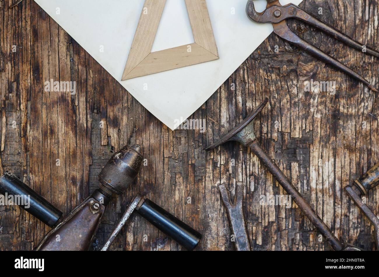 An old hand tool on dark wooden background. Metal pliers. Hand powered ...