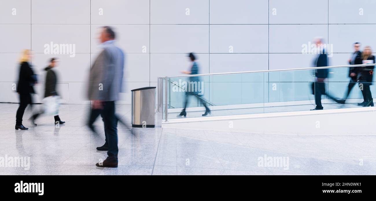 Many anonymous business people go aisle in the office Stock Photo - Alamy