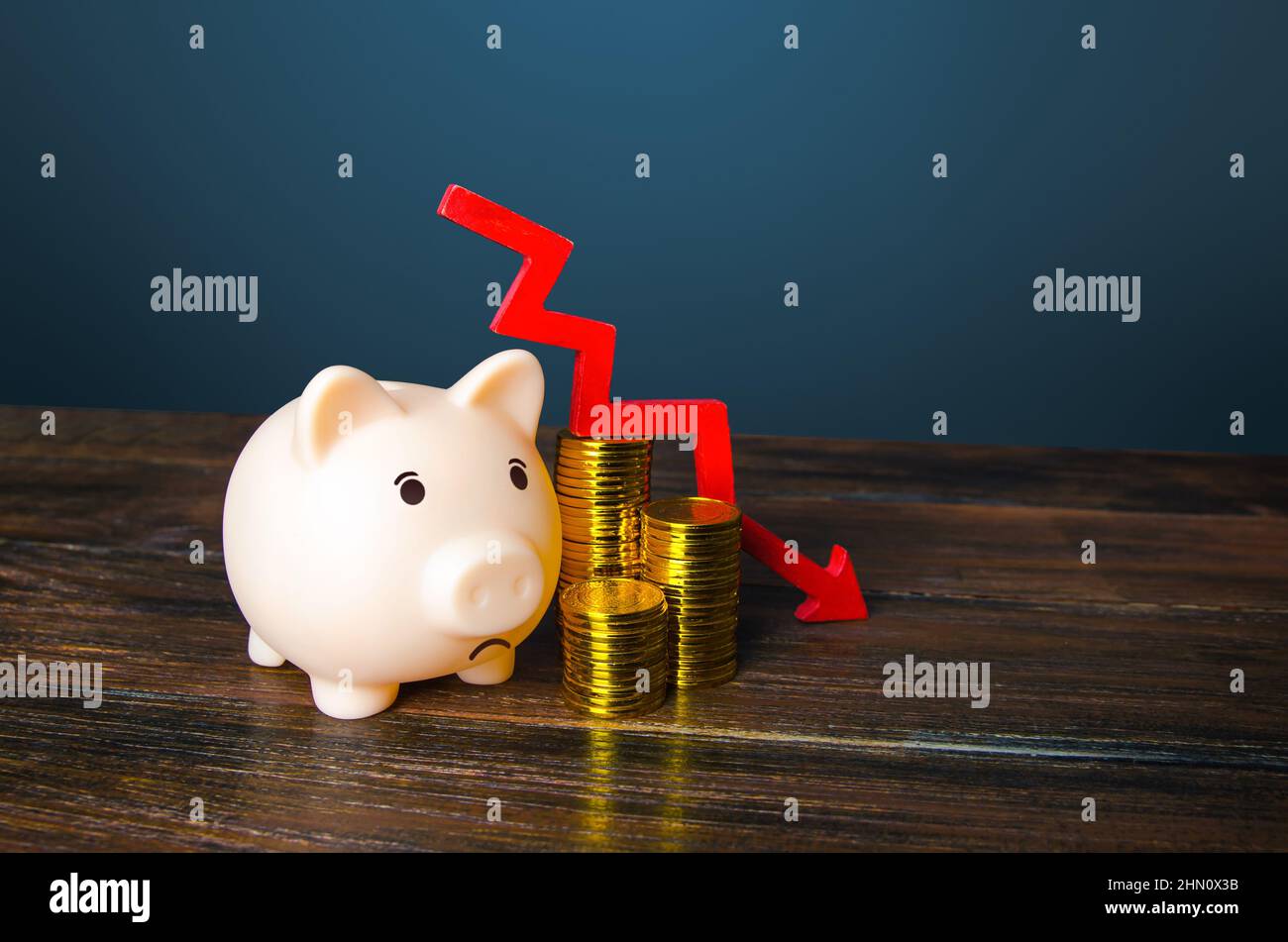 Piggy bank and money with an arrow down. Decrease in savings and ...