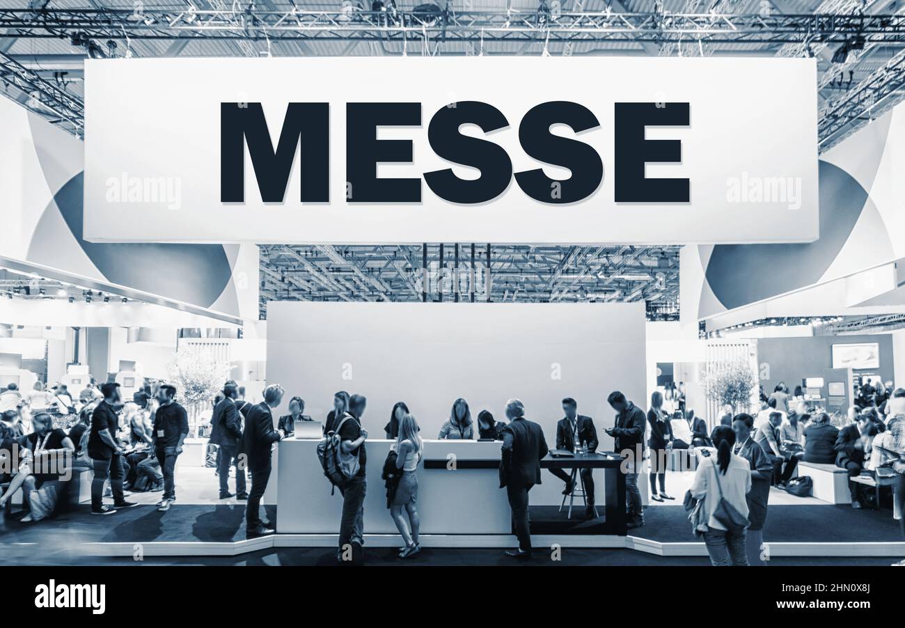 German text Messe, translate Trade Show. Crowd of people at a trade ...