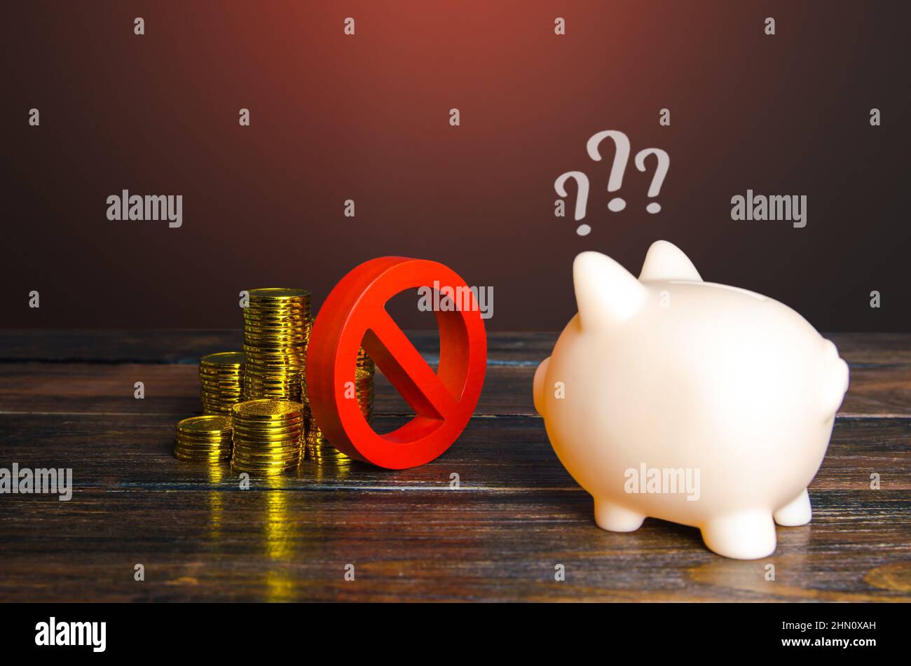 Red prohibition sign NO separates money and piggy bank. Freezing ...