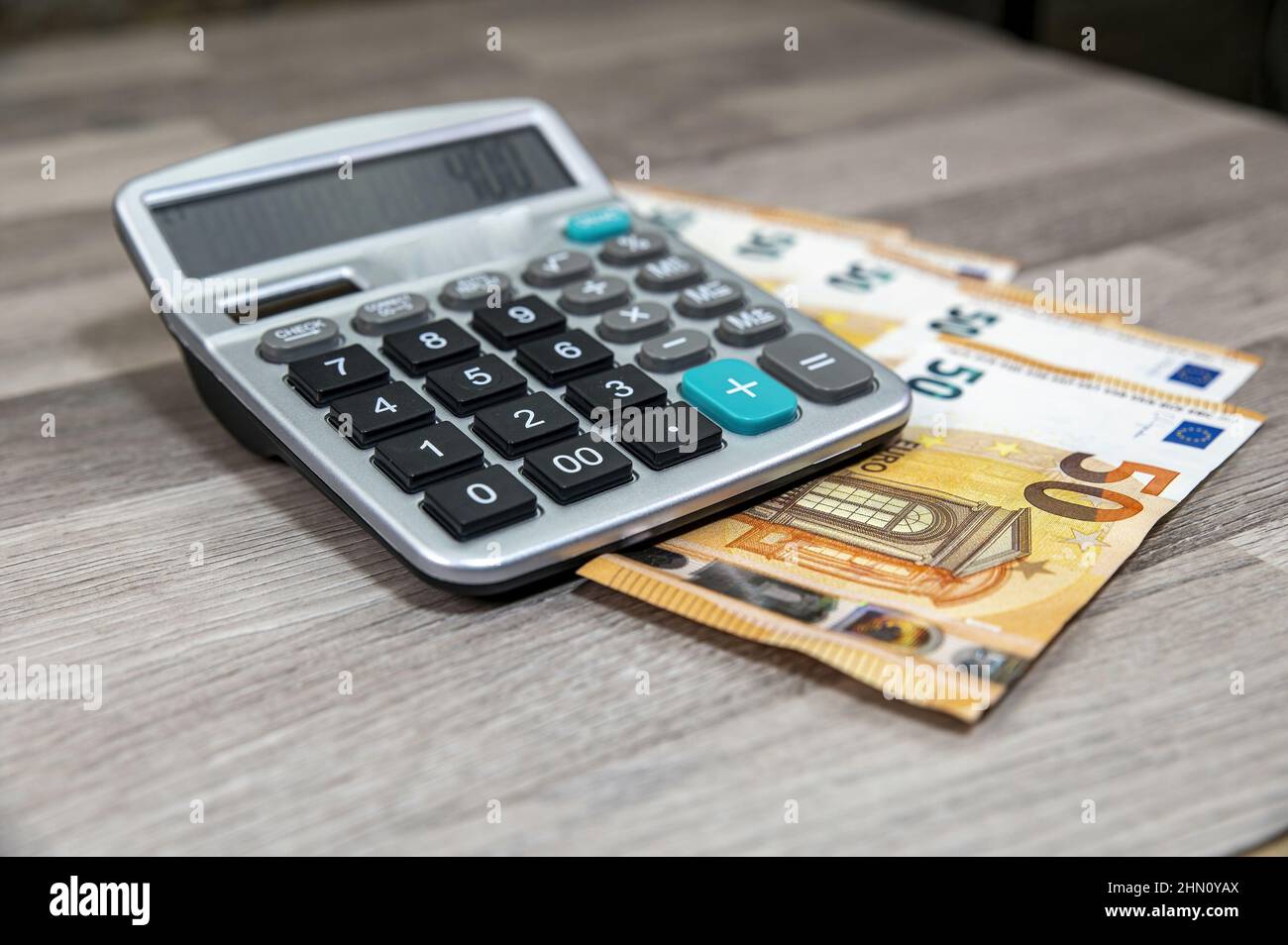 50 euro banknotes with calculator on wooden table Stock Photo - Alamy