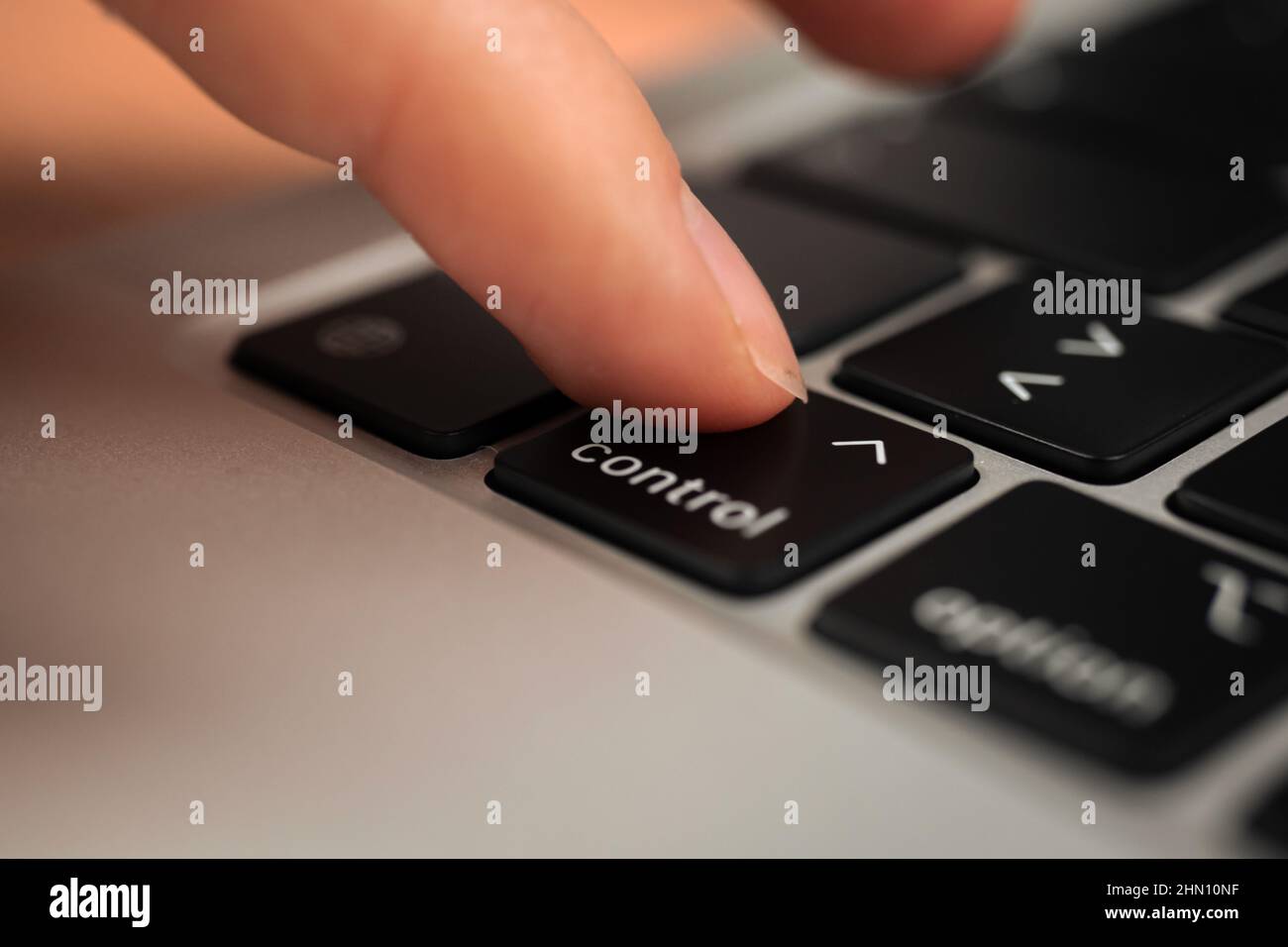 Hand pressing control key on modern laptop keyboard. Control sign and ...