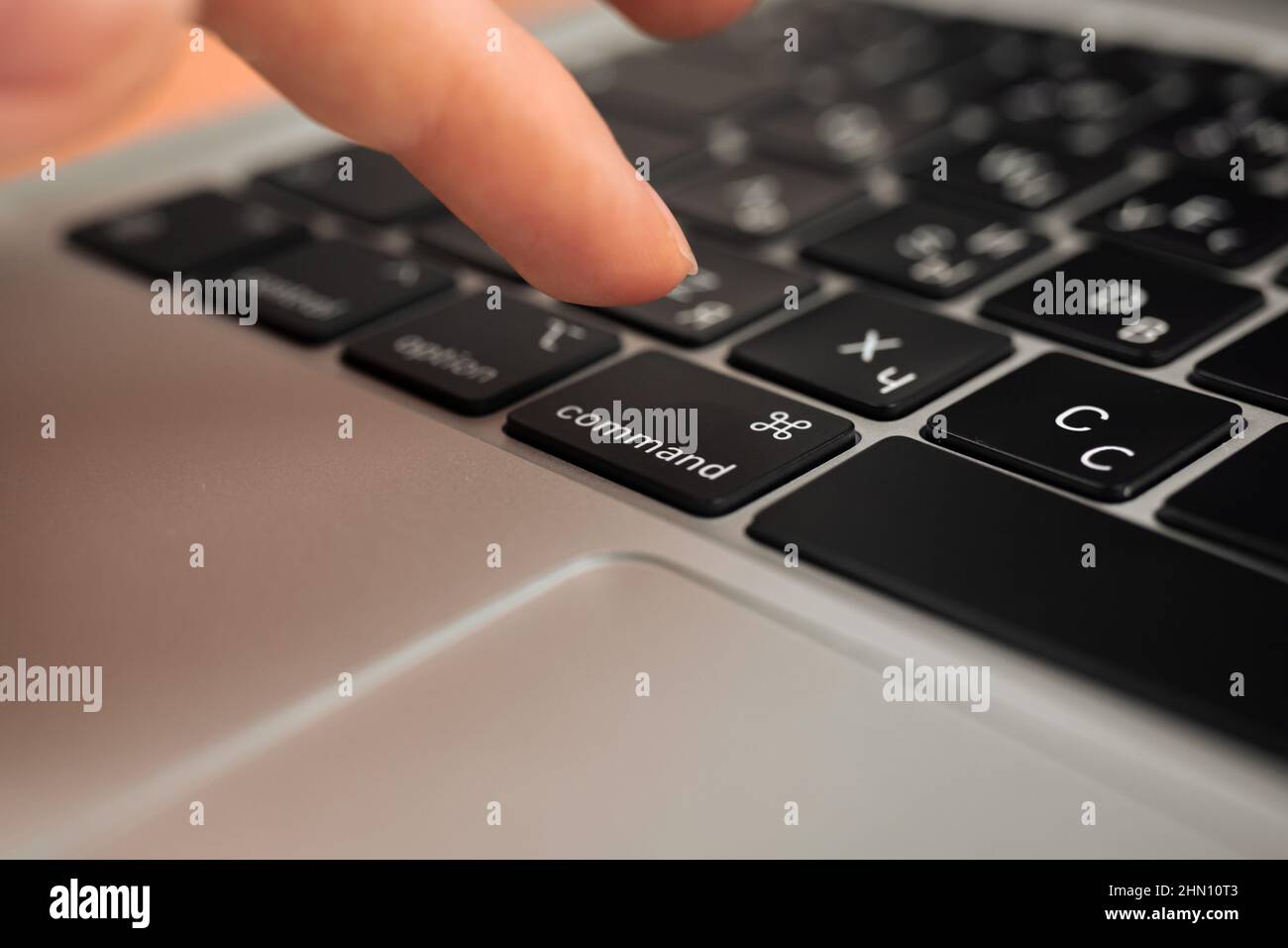 Hand pressing command key on modern laptop keyboard. Command sign and ...