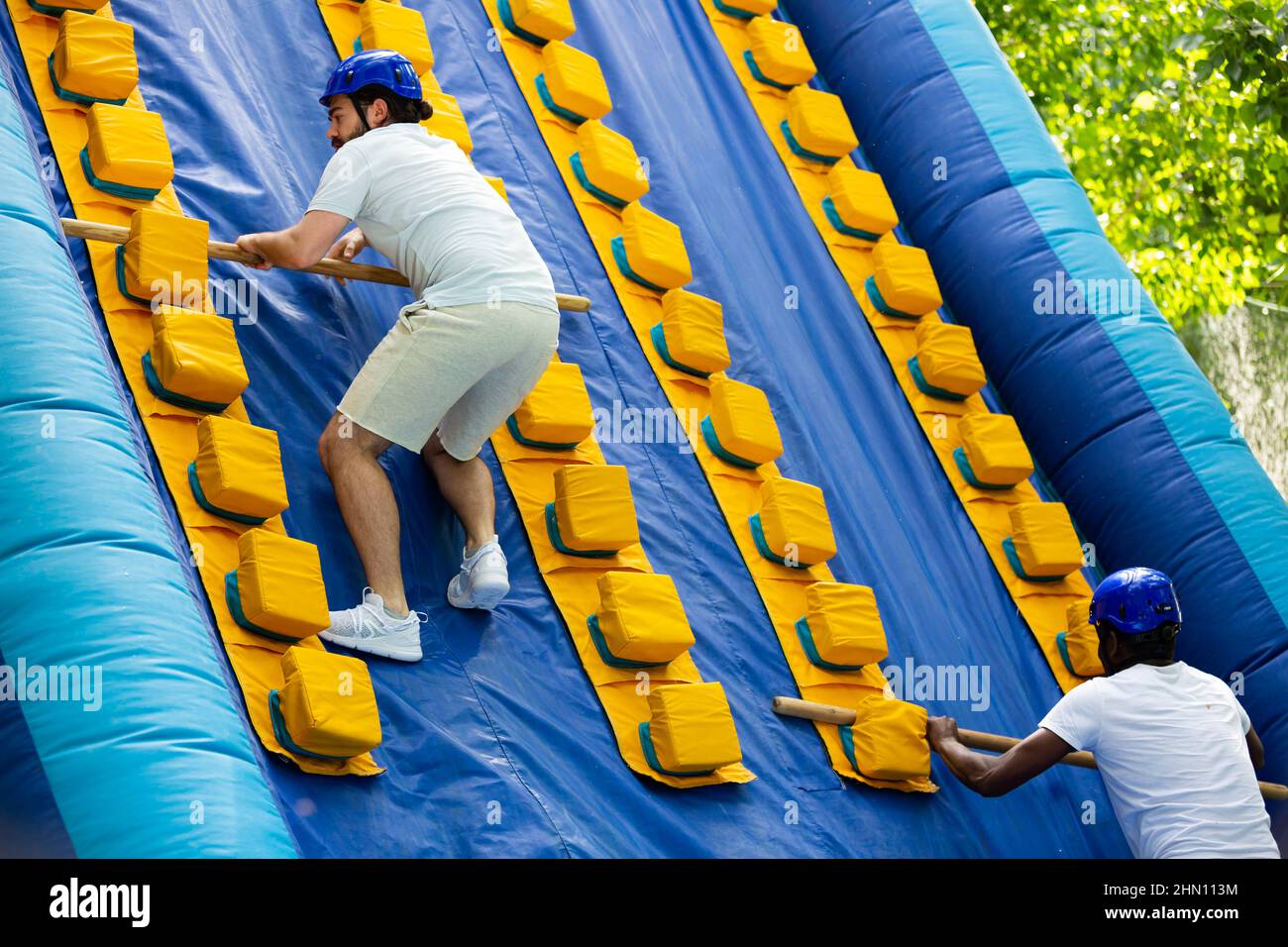 Inflatable slide Great race - climbing with a stick on an inflatable ...