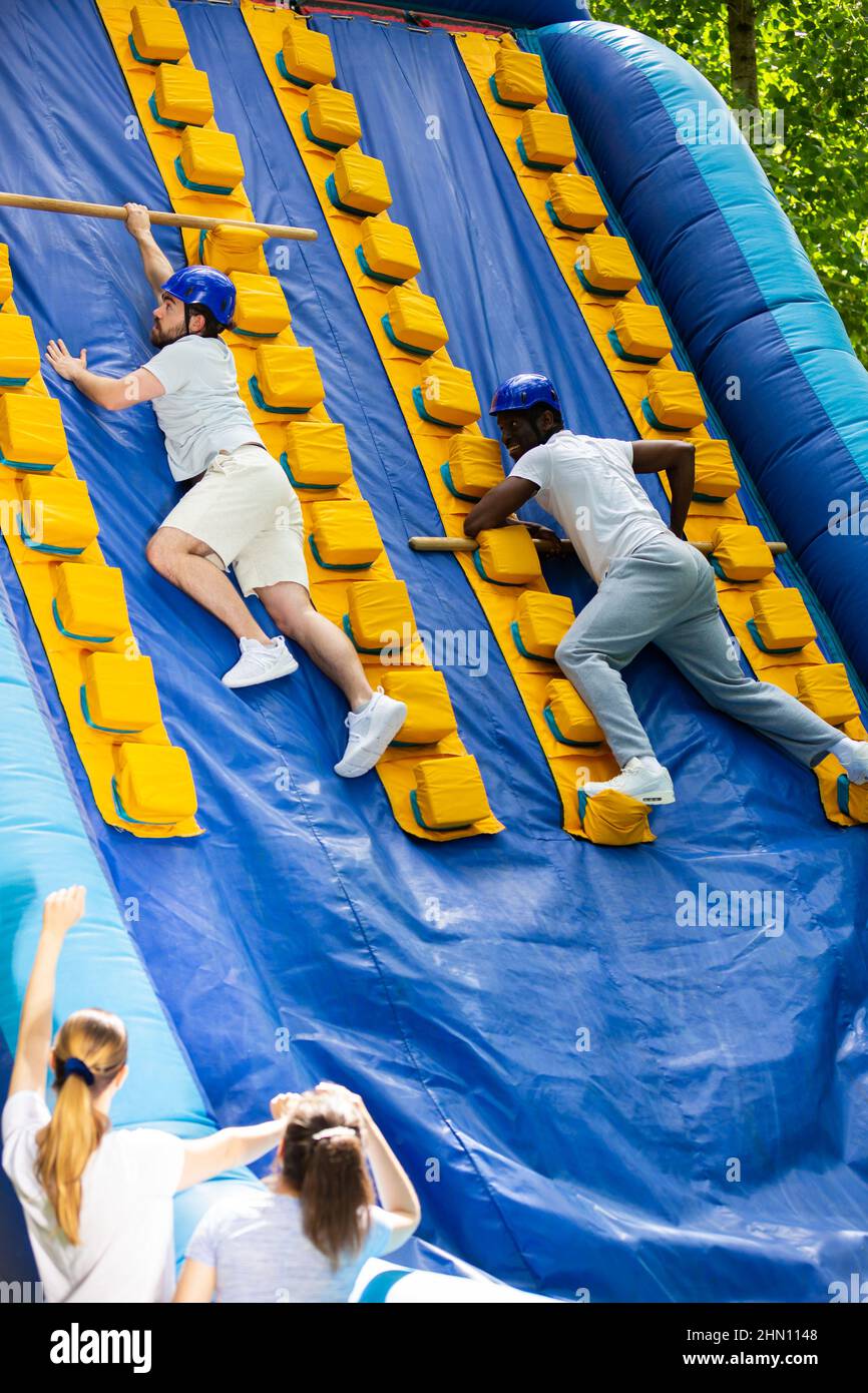 Inflatable slide Great race - climbing with a stick on an inflatable ...