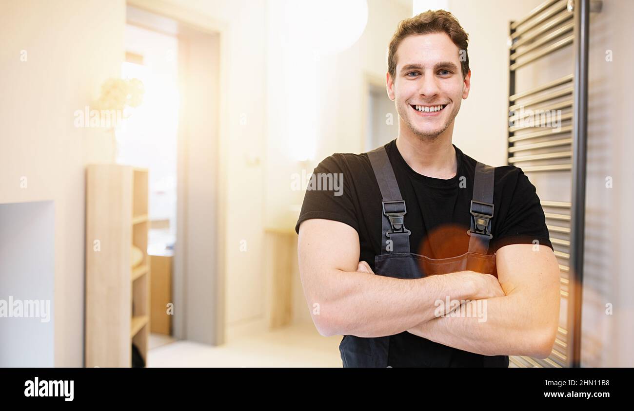 Handsome smiling plumber at the kitchen hi-res stock photography and ...