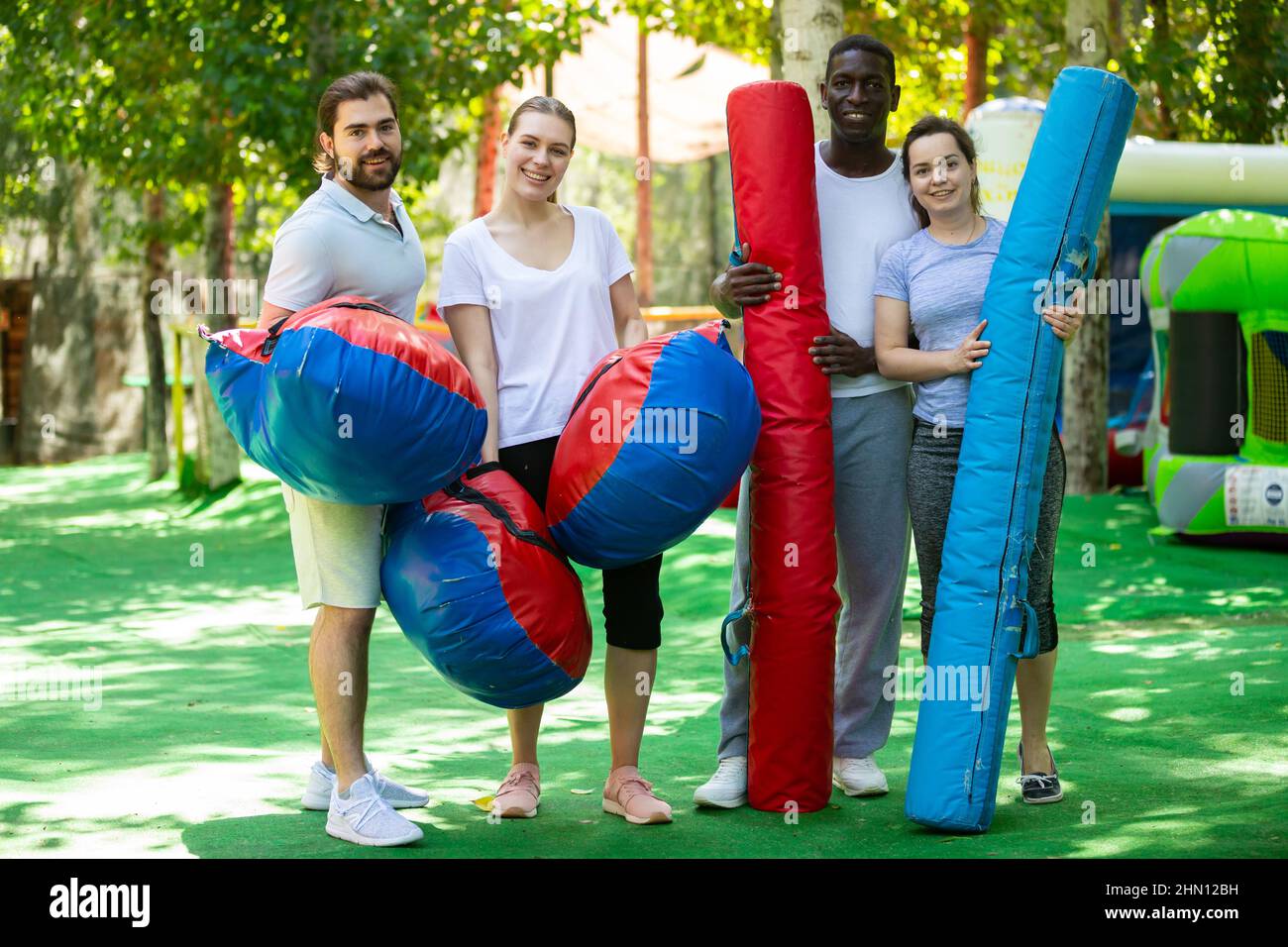 Cheerful people in outdoor inflatable amusement park Stock Photo - Alamy