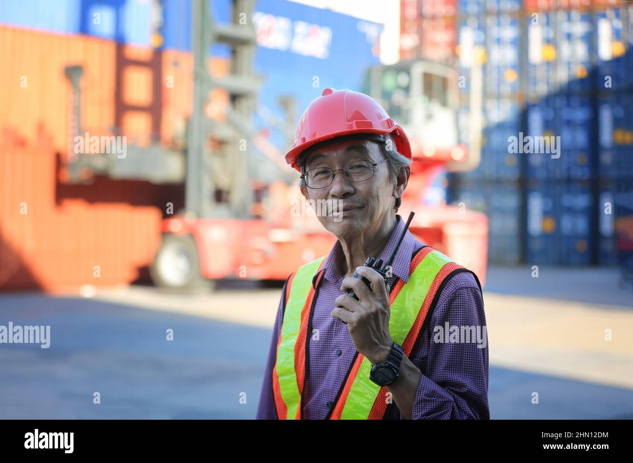 Foreman control loading Containers box from Cargo freight ship for ...