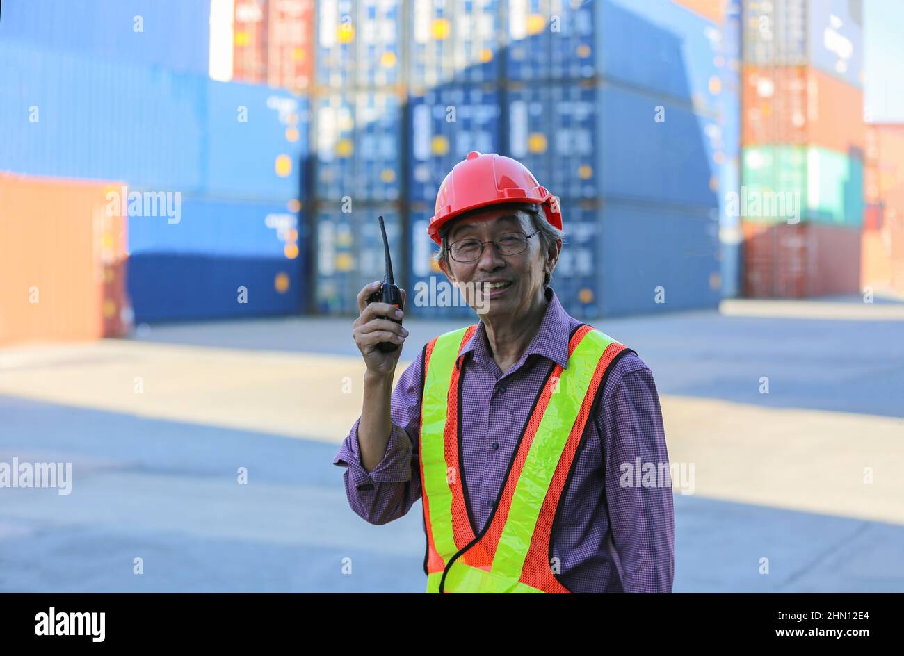 Foreman control loading Containers box from Cargo freight ship for ...