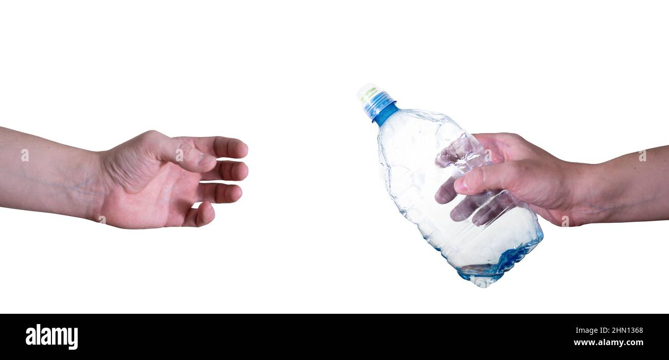 A man passes an empty, plastic bottle, isolated on a white background ...