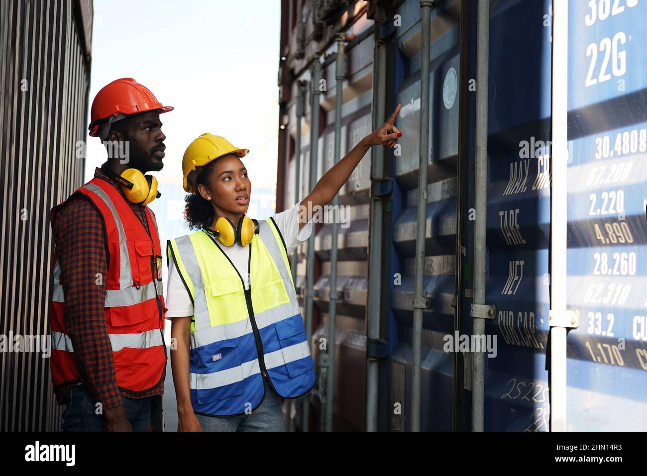Foreman control loading Containers box from Cargo freight ship for ...