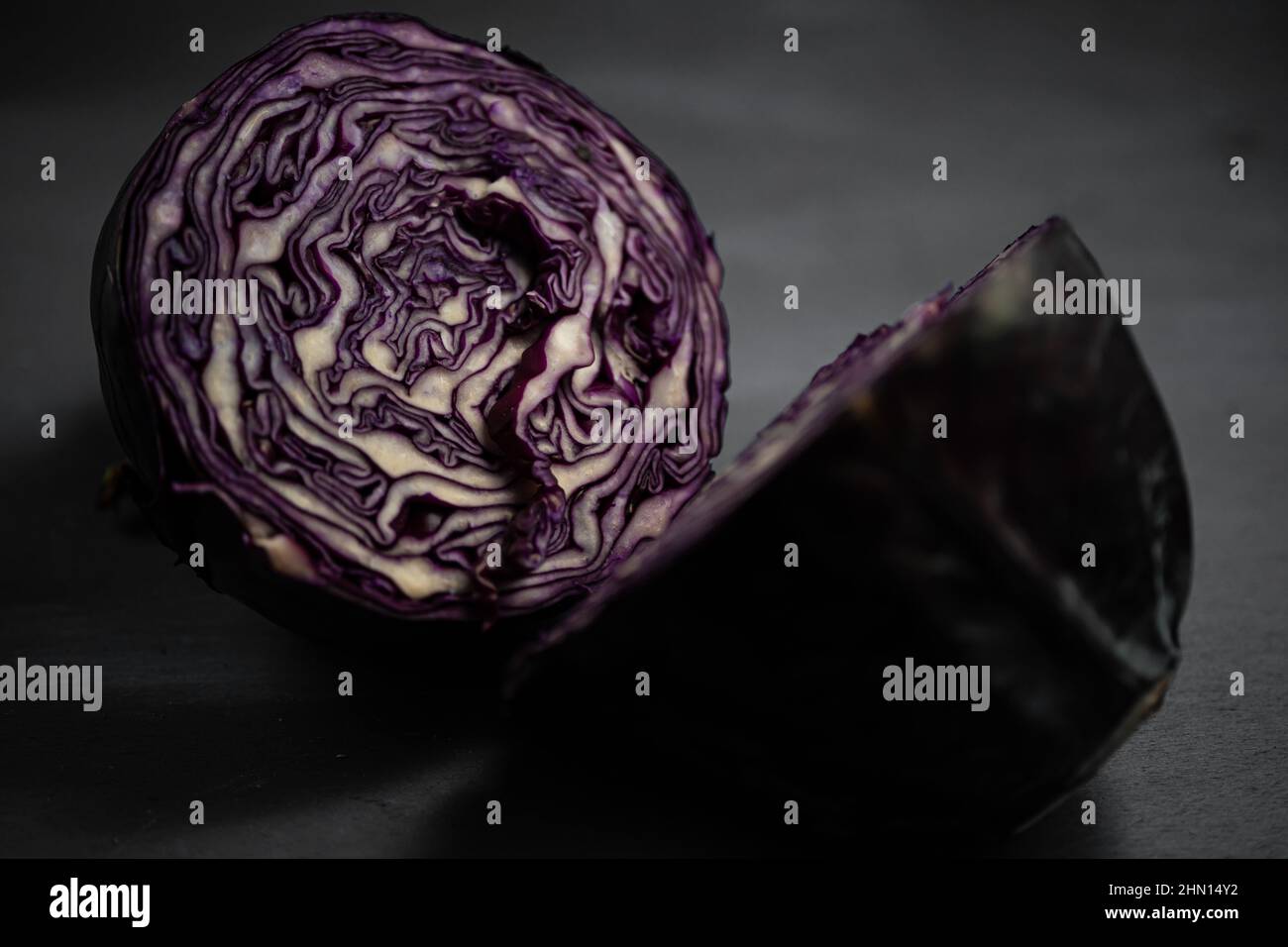 Half red cabbage in dark background. Selective focus on cabbage in ...