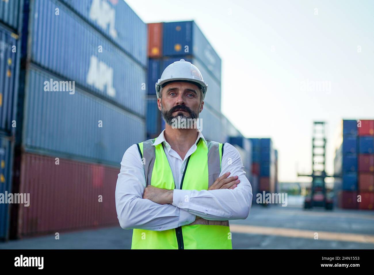 Foreman control loading Containers box from Cargo freight ship for ...