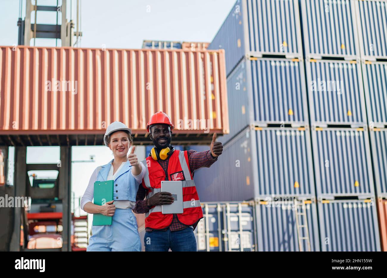 Foreman control loading Containers box from Cargo freight ship for ...