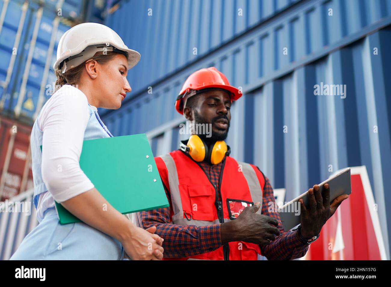 Foreman control loading Containers box from Cargo freight ship for ...