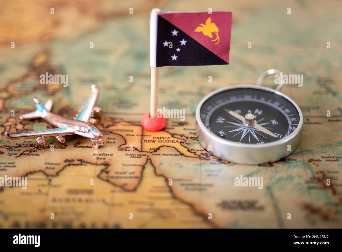 flag of Papua New Guinea, compass and airplane on the world map. The ...