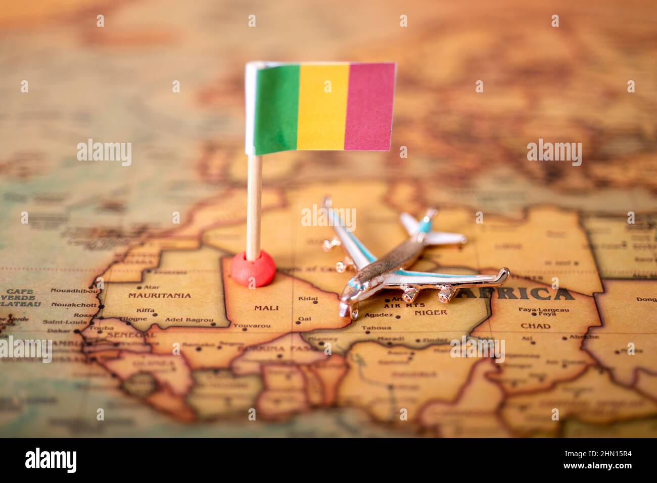 The flag of Mali and the plane on the world map. The concept of travel ...