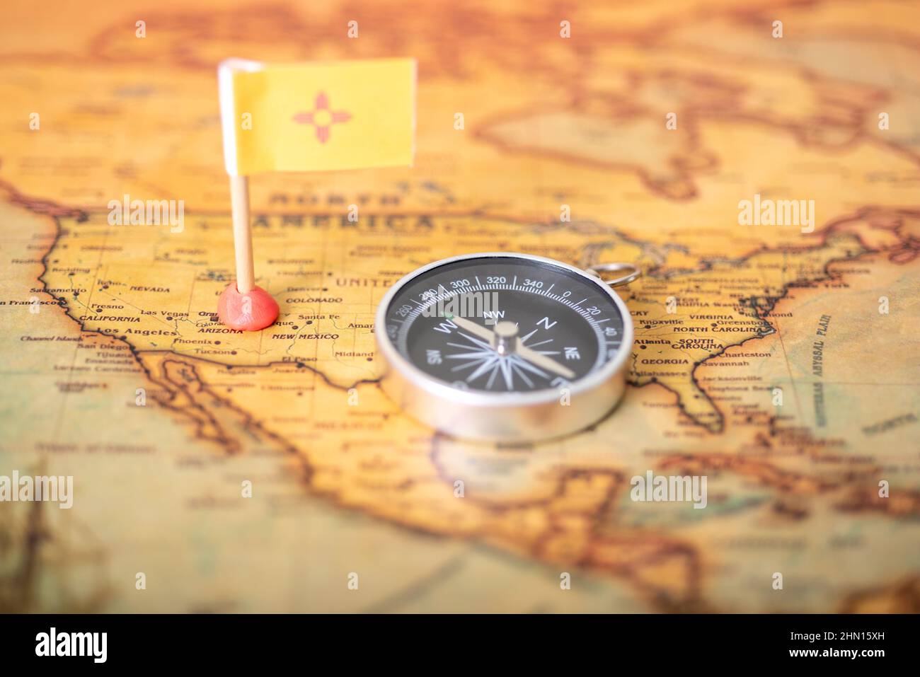 The flag of New Mexico and the compass of the old world map. The ...