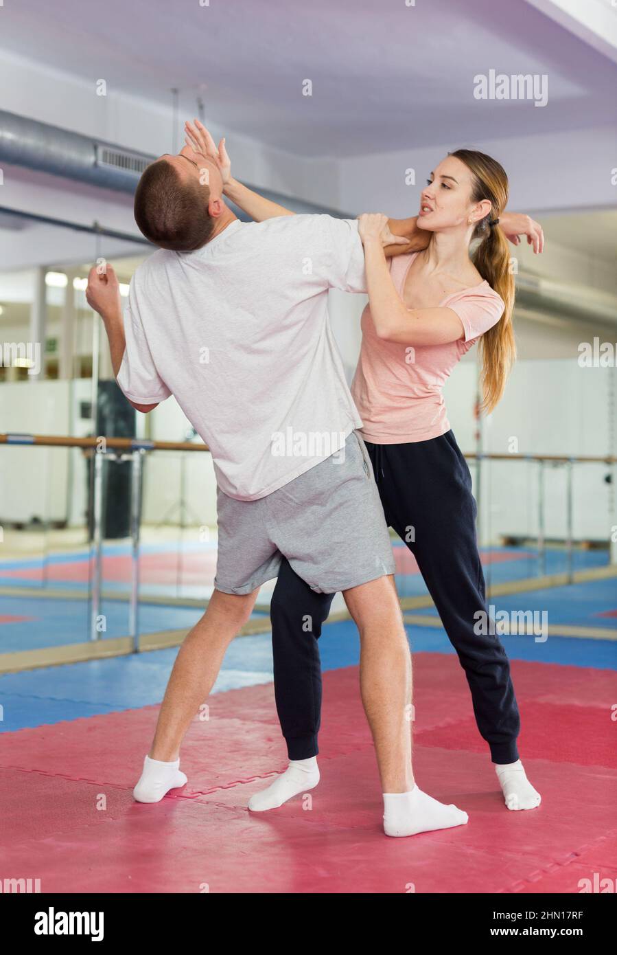 Self-defense course - a woman trains to do painful grip and painful ...