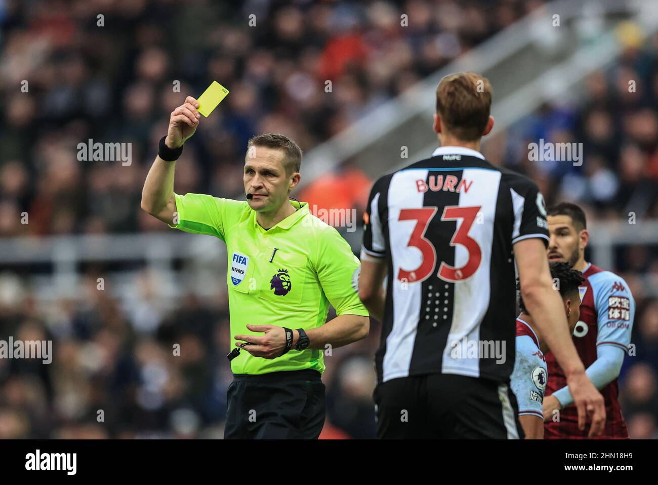Referee Craig Pawson gives a yellow card to Dan Burn #33 of Newcastle United Stock Photo - Alamy