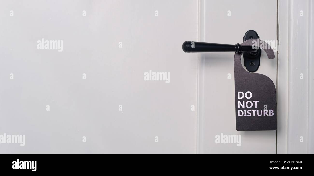 Do not disturb text sign, hotel room hanger. Black label on closed ...