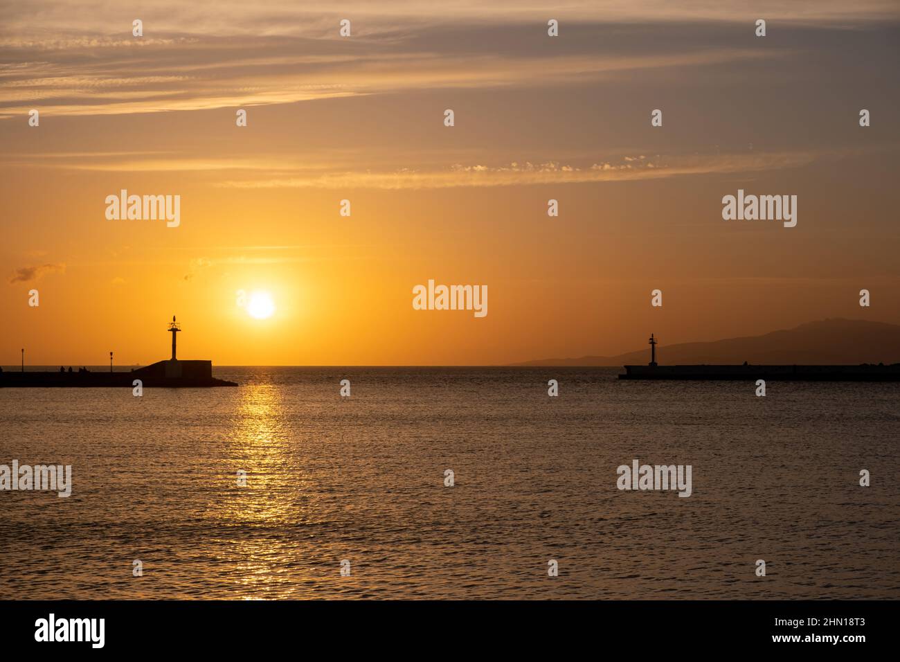 Sunset over Mykonos island, Cyclades, Greece. Lighthouse, beacon ...