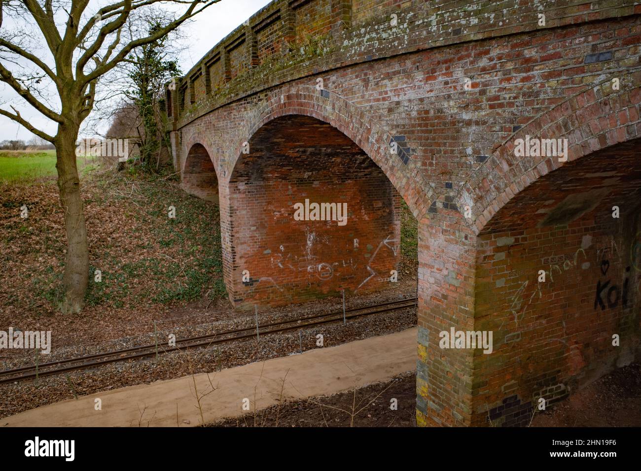 Bridge constructed from red brick over the Bure Valley Railway line in ...