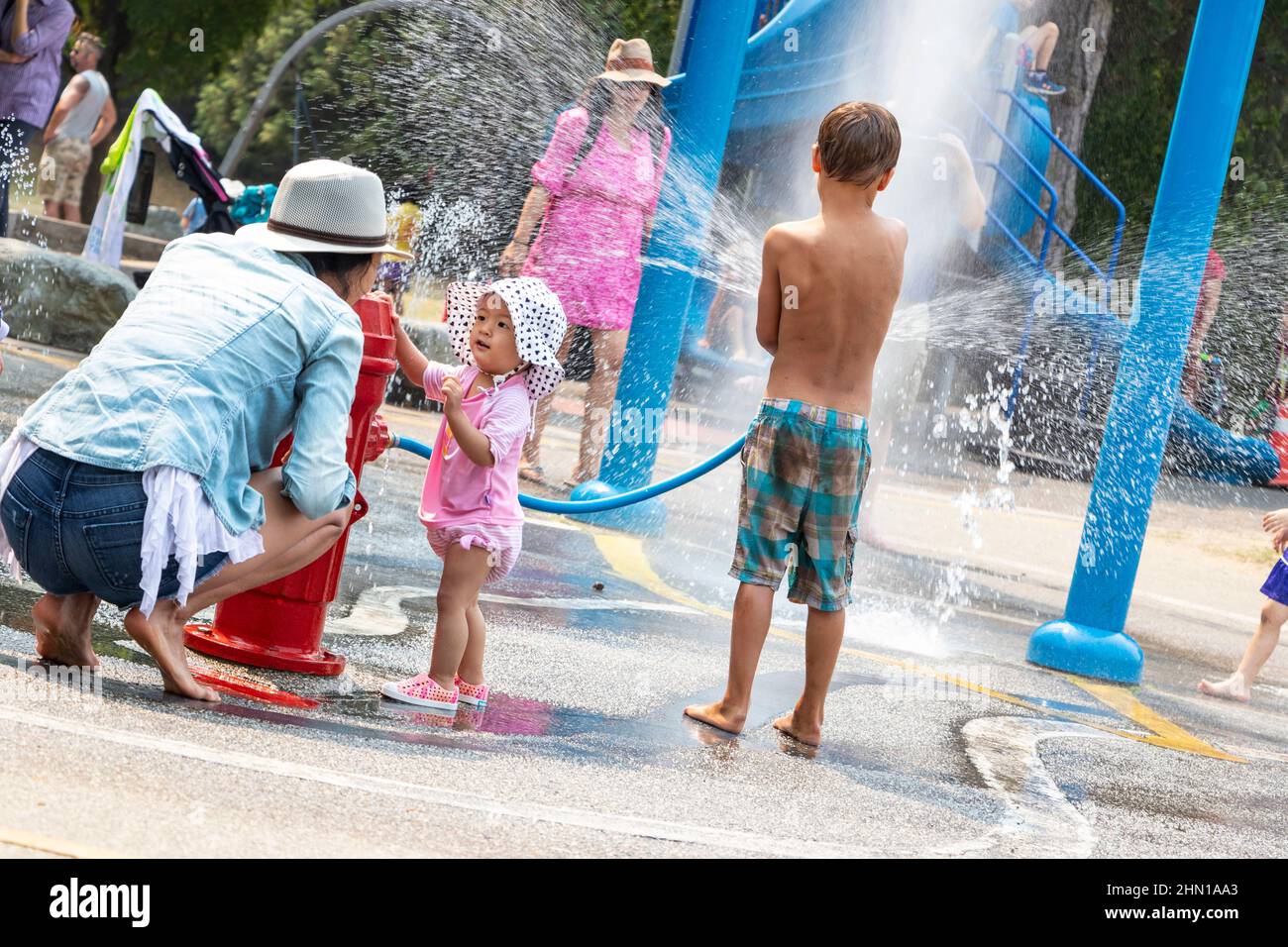 Children playing fire hydrant hi-res stock photography and images - Alamy