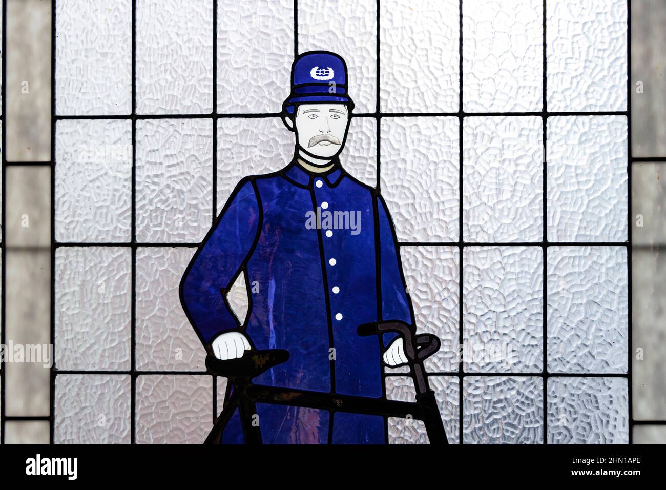 stained glass window showing victorian policeman and bicycle at the ...