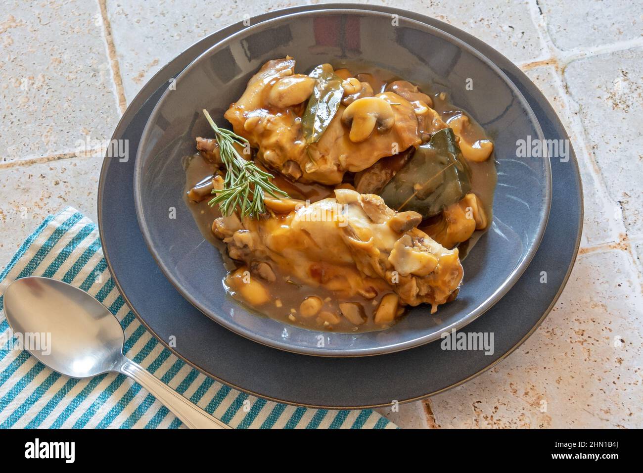 rabbit cooked in mushroom sauce in a dish Stock Photo - Alamy