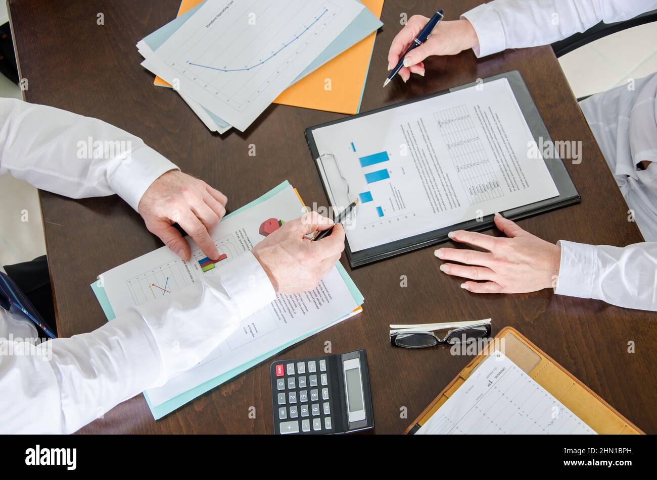 Two business people analyzing charts Stock Photo - Alamy