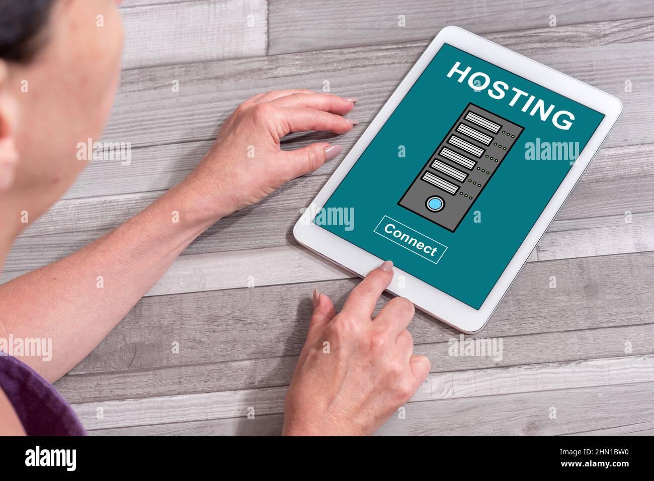 Woman using a tablet showing hosting concept Stock Photo - Alamy
