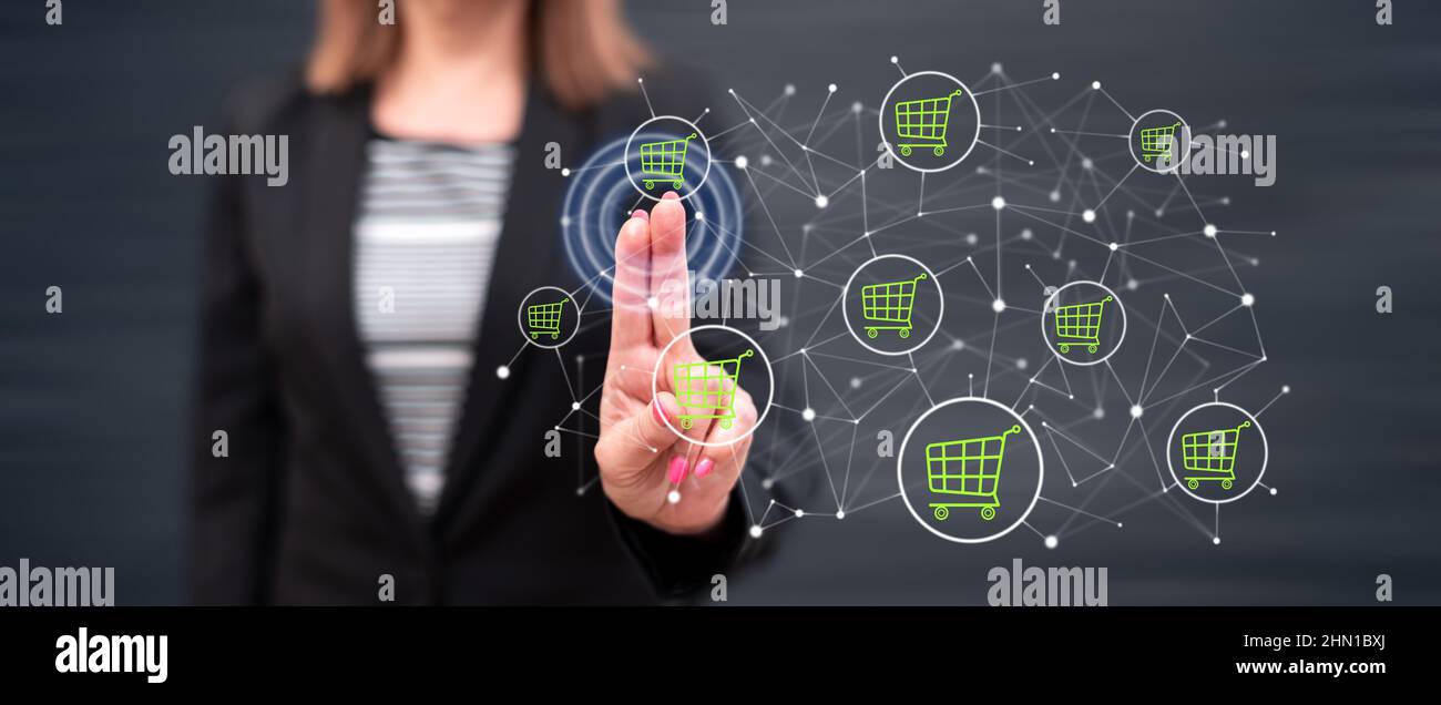 Woman touching an e-commerce concept on a touch screen with her fingers ...