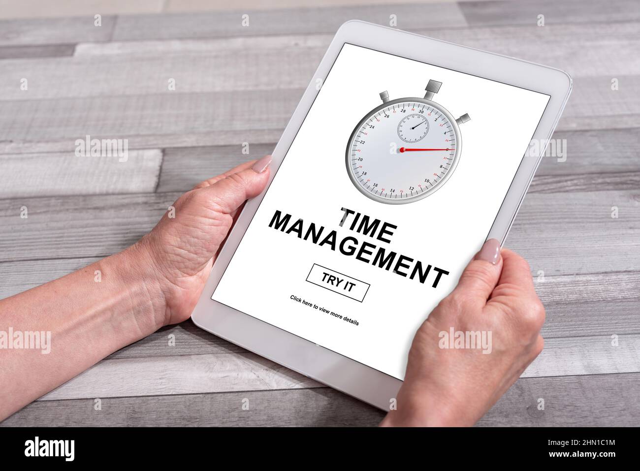 Female hands holding a tablet with time management concept Stock Photo ...