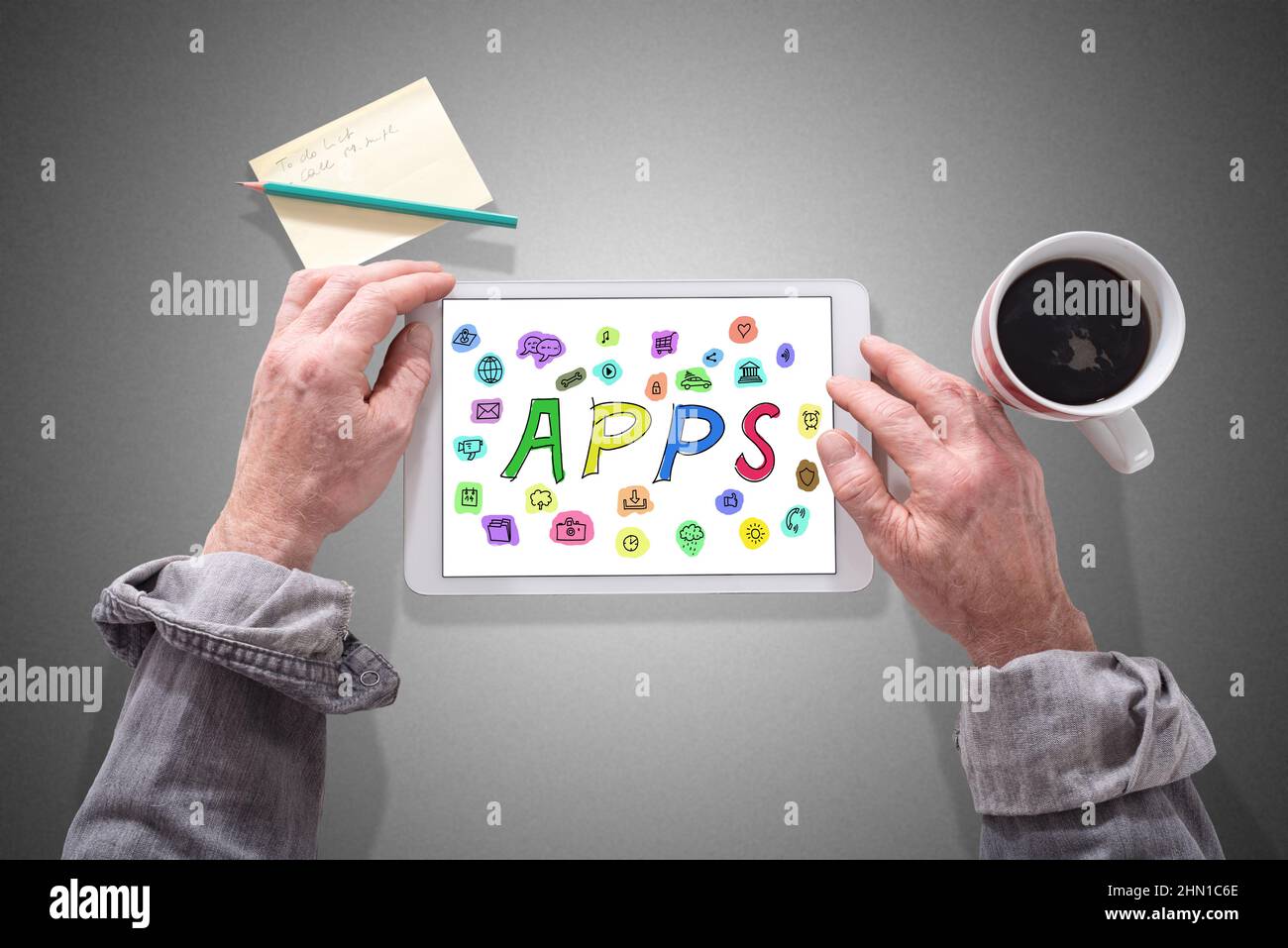 Male hands using a tablet showing apps concept Stock Photo - Alamy