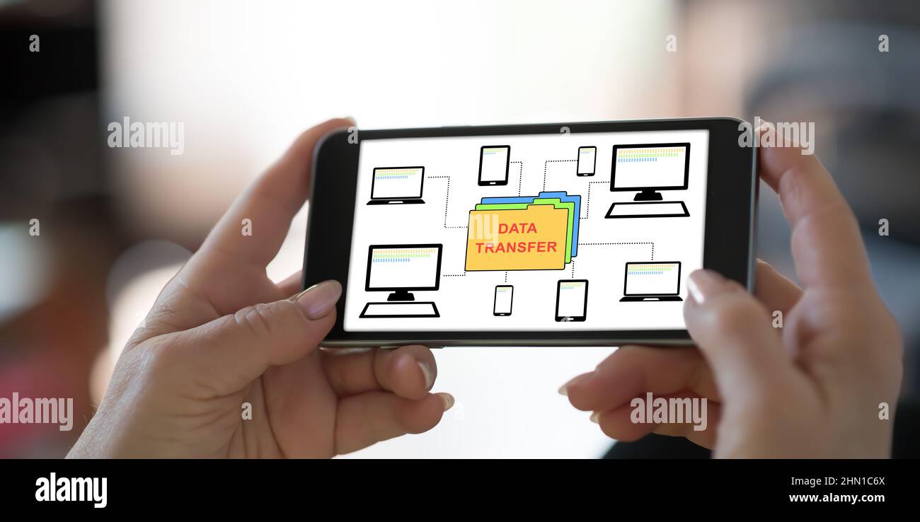 Hand holding a smartphone with data transfer concept Stock Photo - Alamy