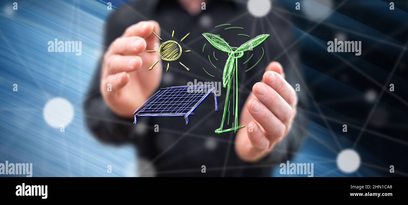 Green energy concept between hands of a man in background Stock Photo ...