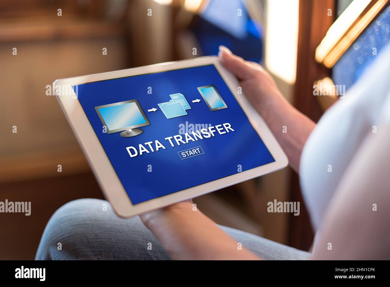 Woman holding a tablet showing data transfer concept Stock Photo - Alamy