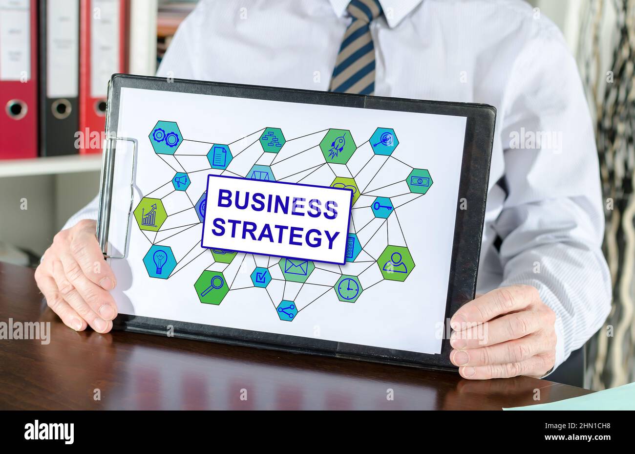Business strategy concept shown by a businessman Stock Photo - Alamy